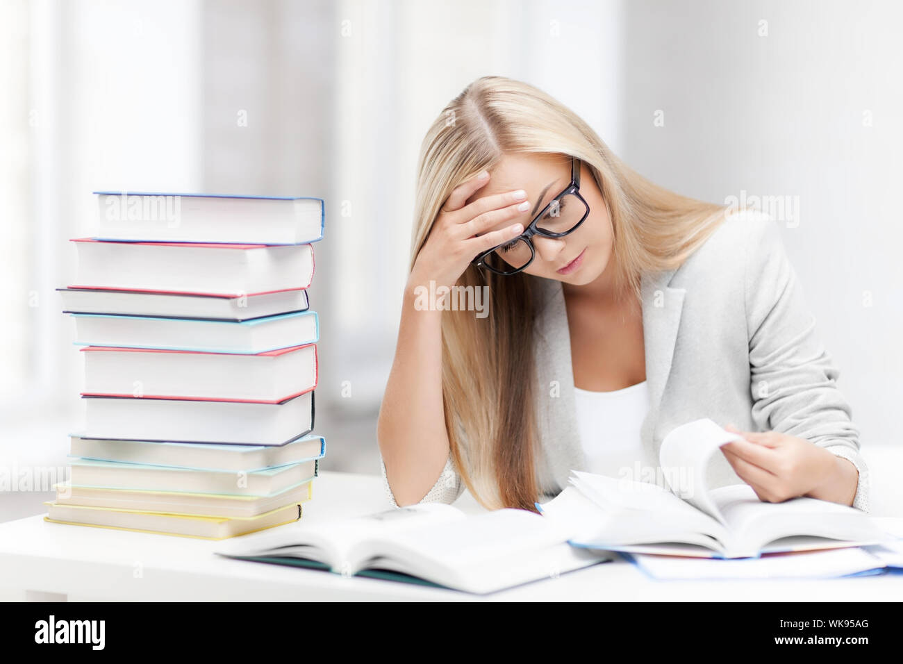 student with pile of books and notes studying indoors Stock Photo - Alamy