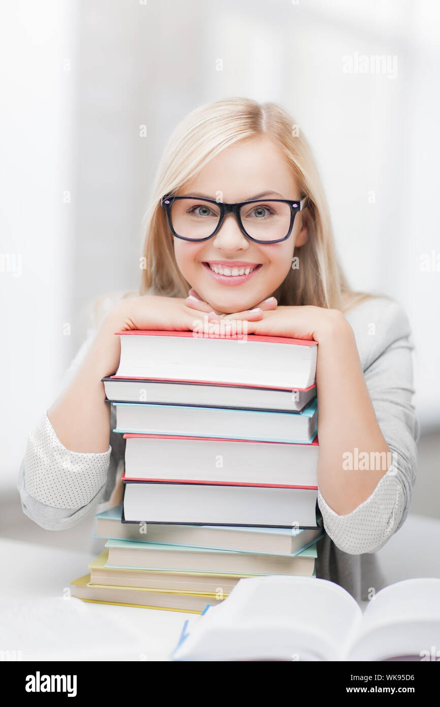 student with stack of books Stock Photo - Alamy