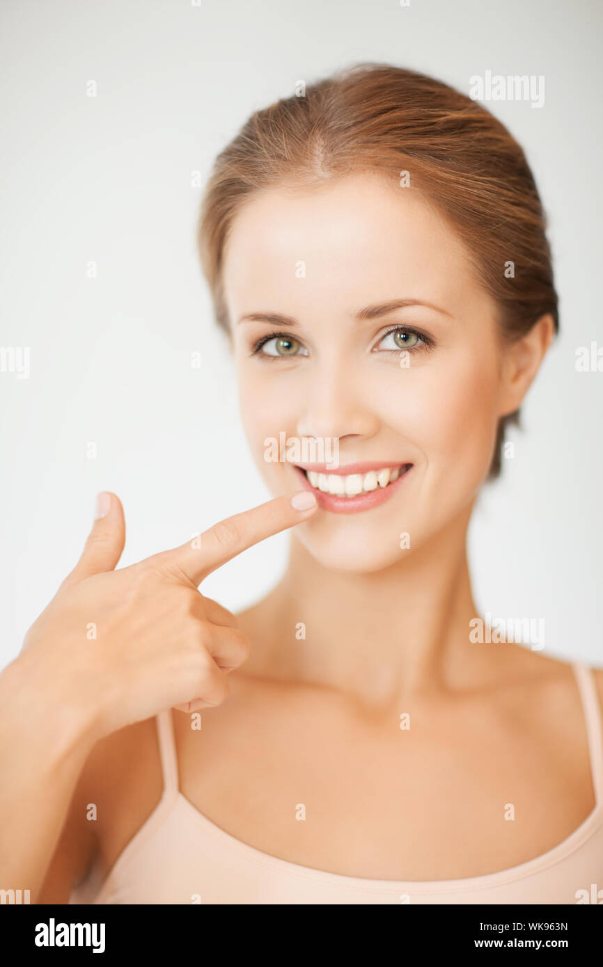 face of beautiful woman showing her teeth Stock Photo - Alamy