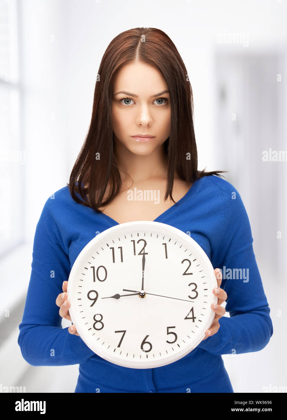 woman holding big clock Stock Photo - Alamy