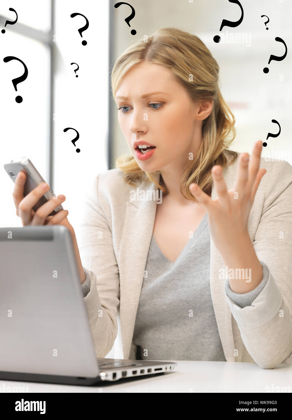 picture of confused woman with cell phone Stock Photo - Alamy