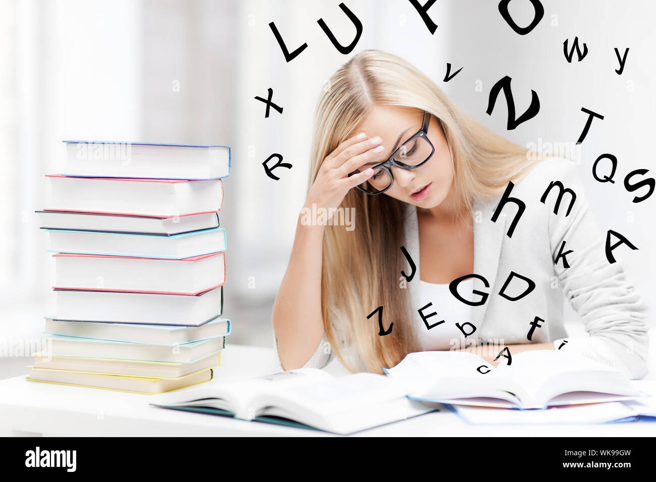 student with pile of books and notes studying indoors Stock Photo - Alamy