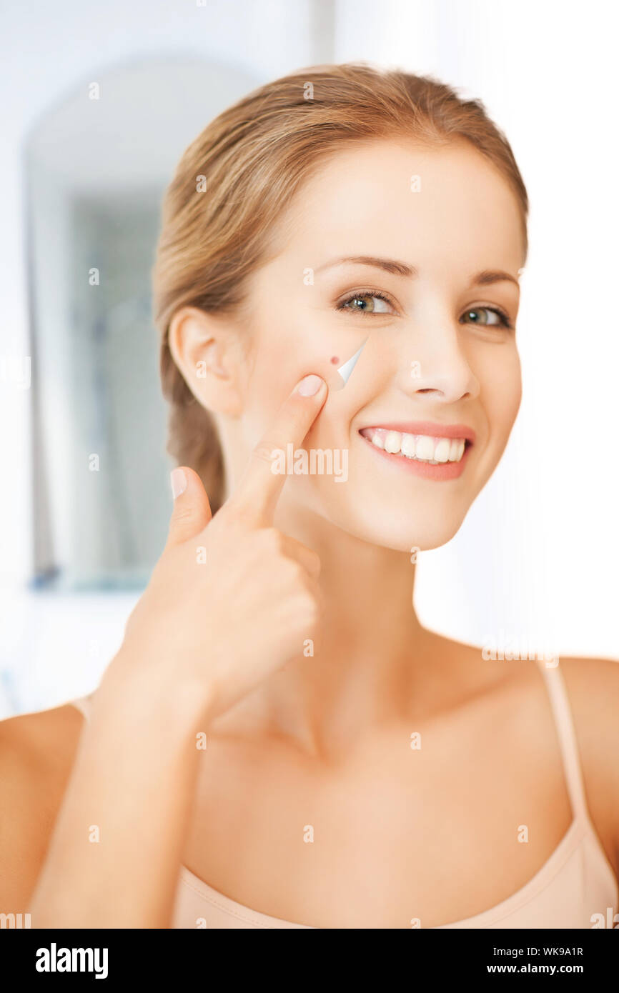 picture of beautiful woman pointing to nose Stock Photo - Alamy