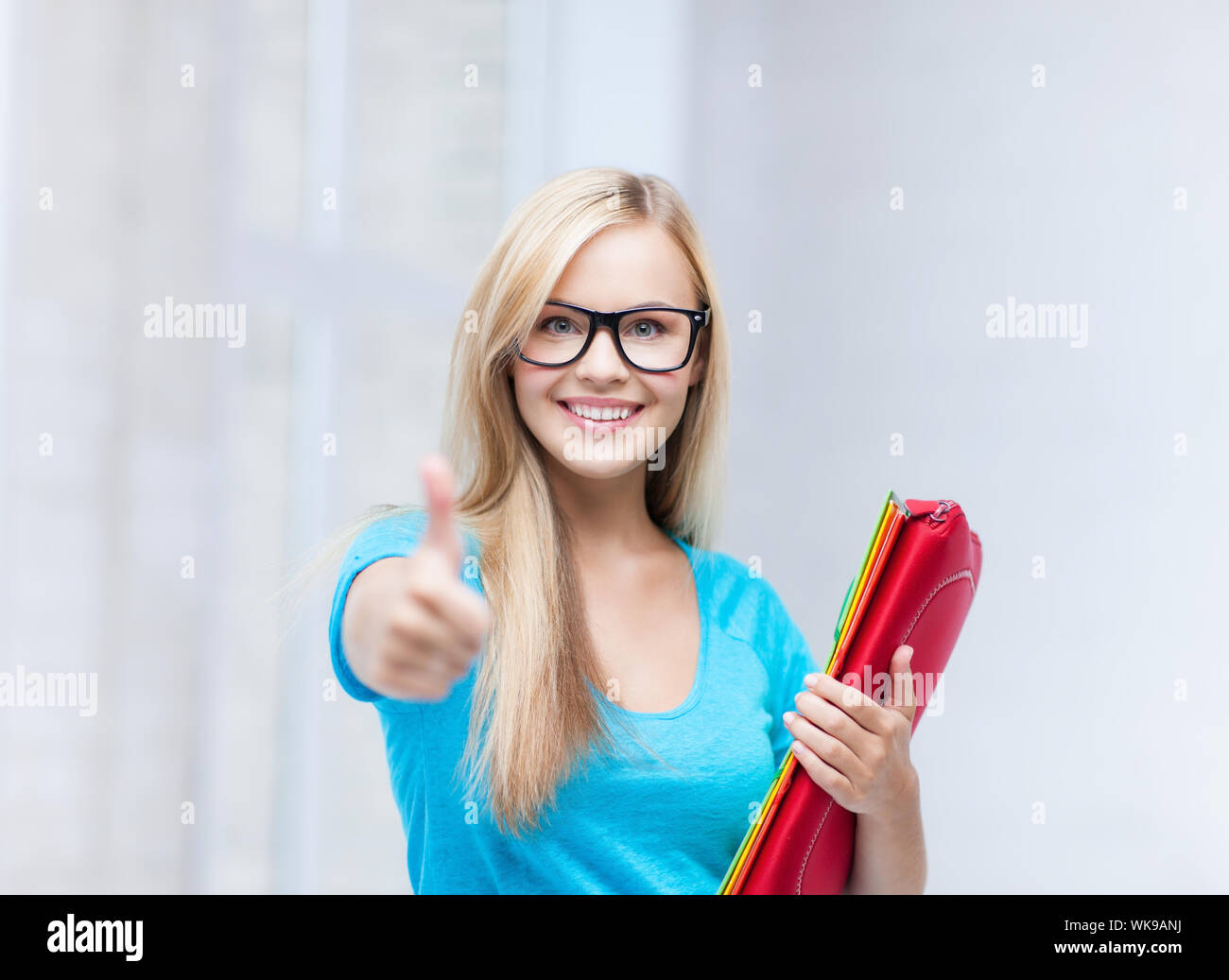 smiling student with folders Stock Photo - Alamy