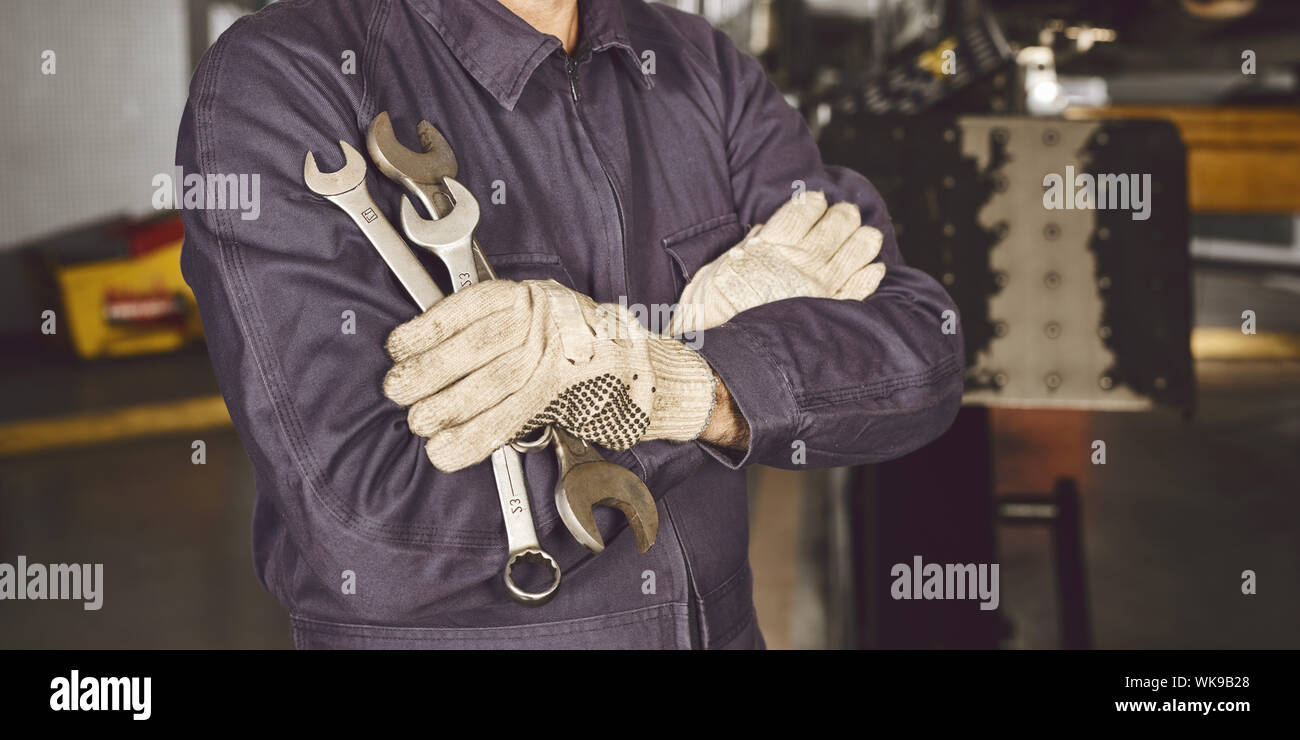 Mechatronics engineer with tool in his hand in a car workshop Stock ...