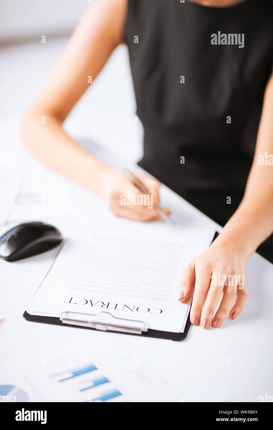 picture of woman thinking about signing a contract Stock Photo - Alamy