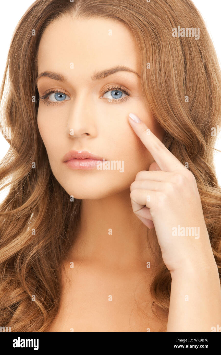 woman pointing at her eye area Stock Photo - Alamy