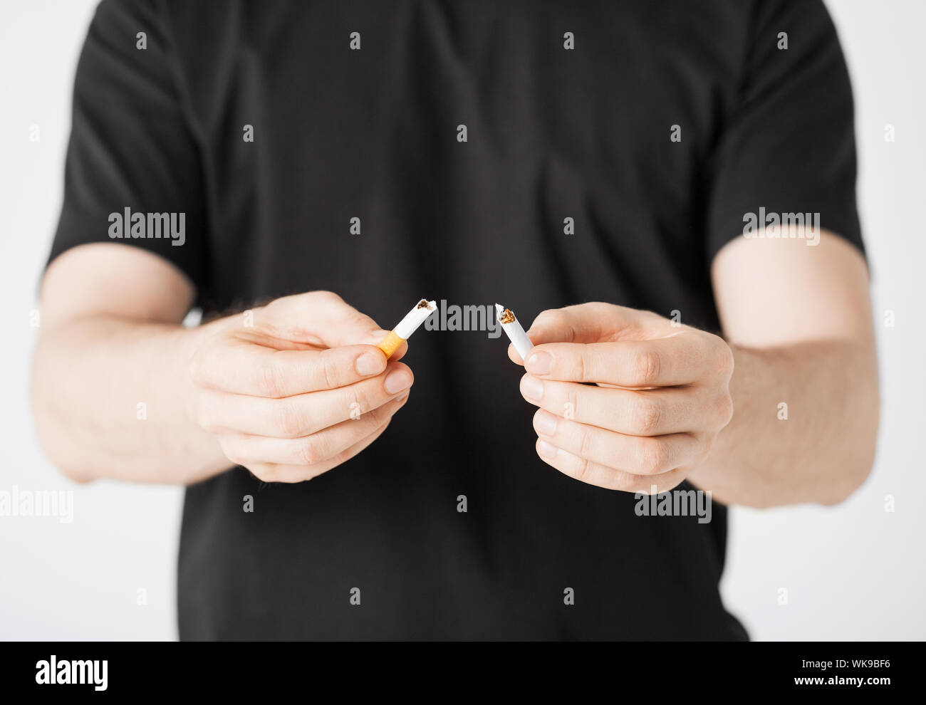 man breaking the cigarette with hands Stock Photo - Alamy
