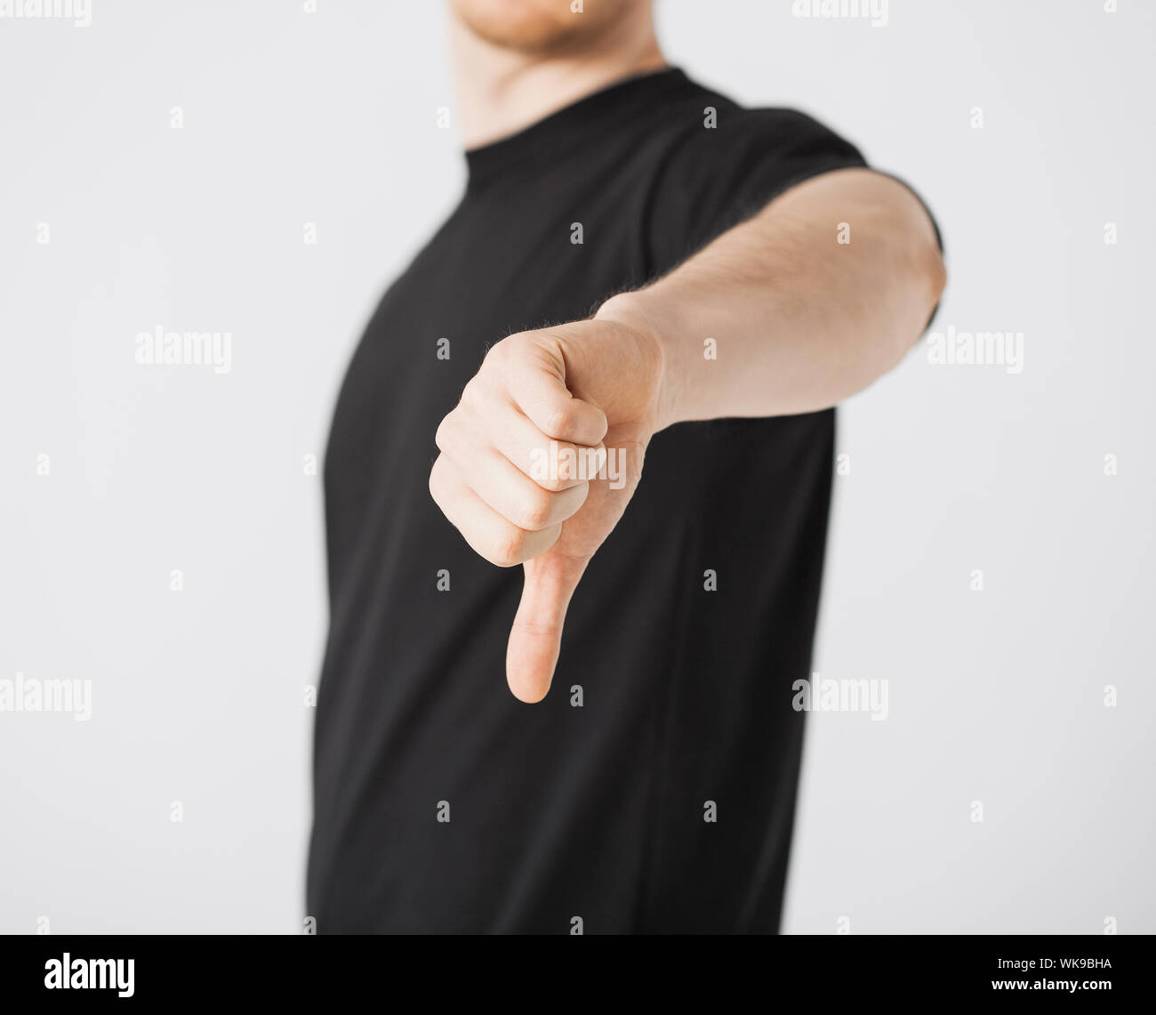 man showing thumbs down Stock Photo - Alamy