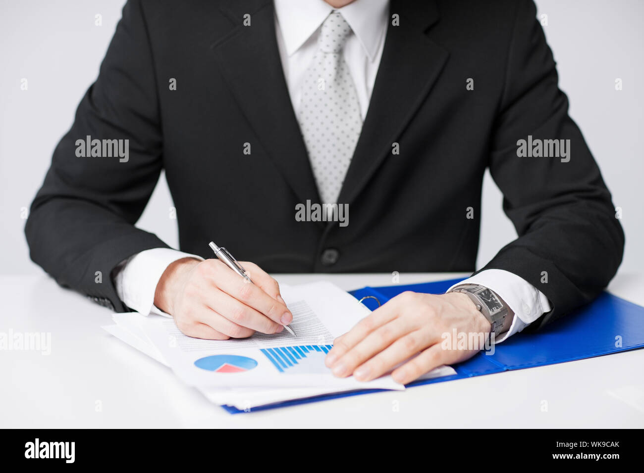 picture of businessman working and signing with papers Stock Photo - Alamy