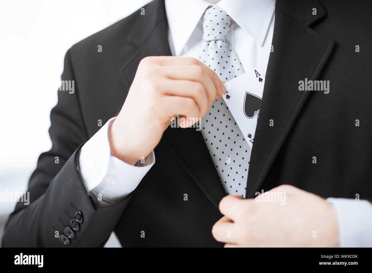 mans hand hiding ace in the sleeve Stock Photo - Alamy