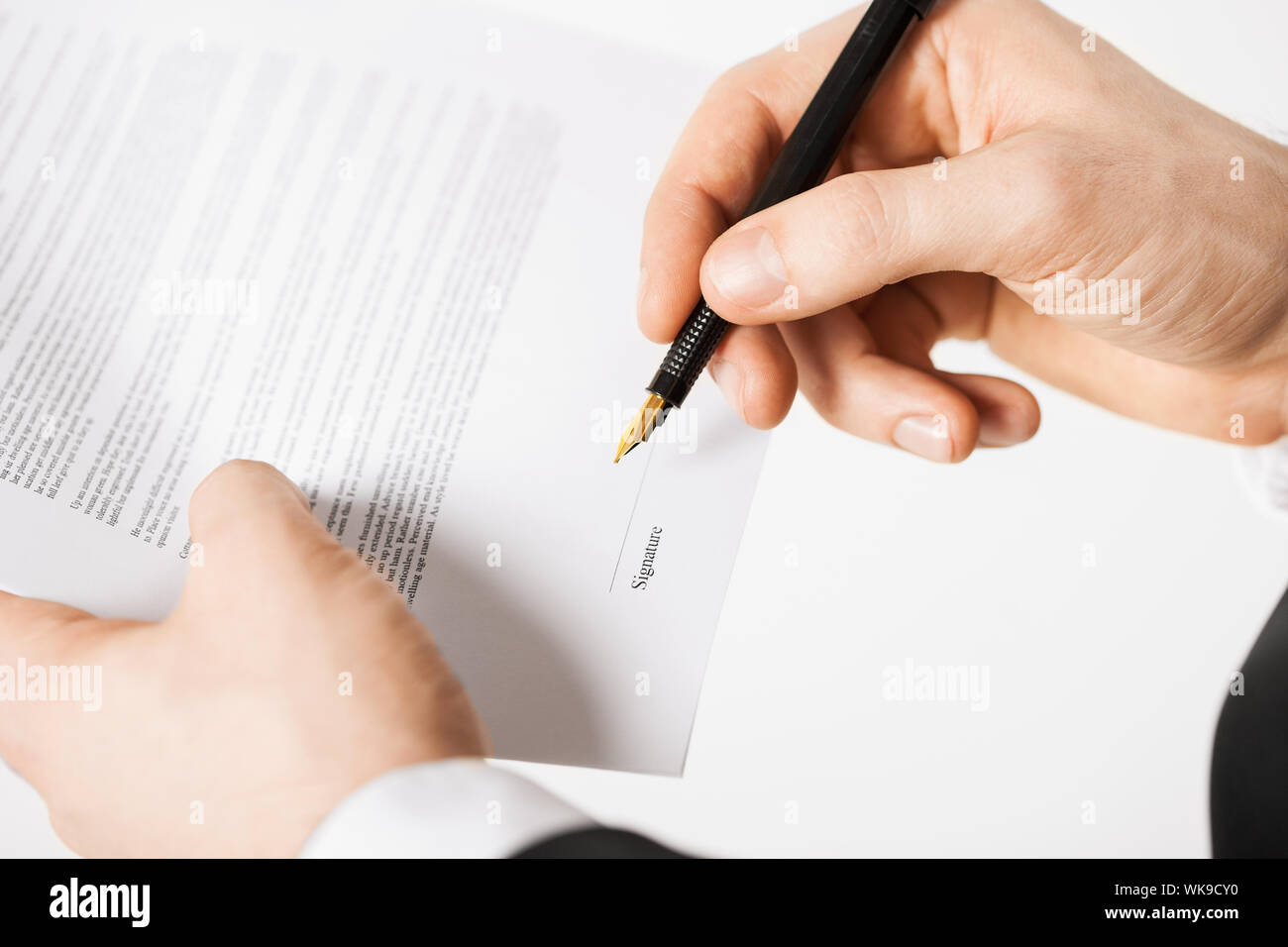 picture of man hands signing contract with random text Stock Photo - Alamy