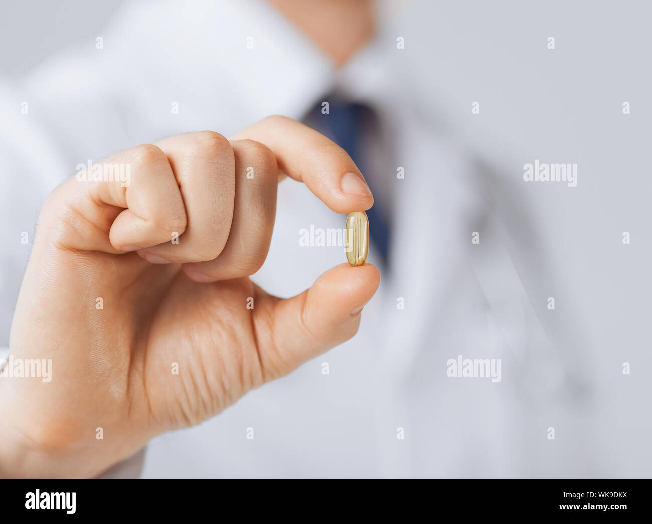 doctor hand showing one capsule Stock Photo - Alamy