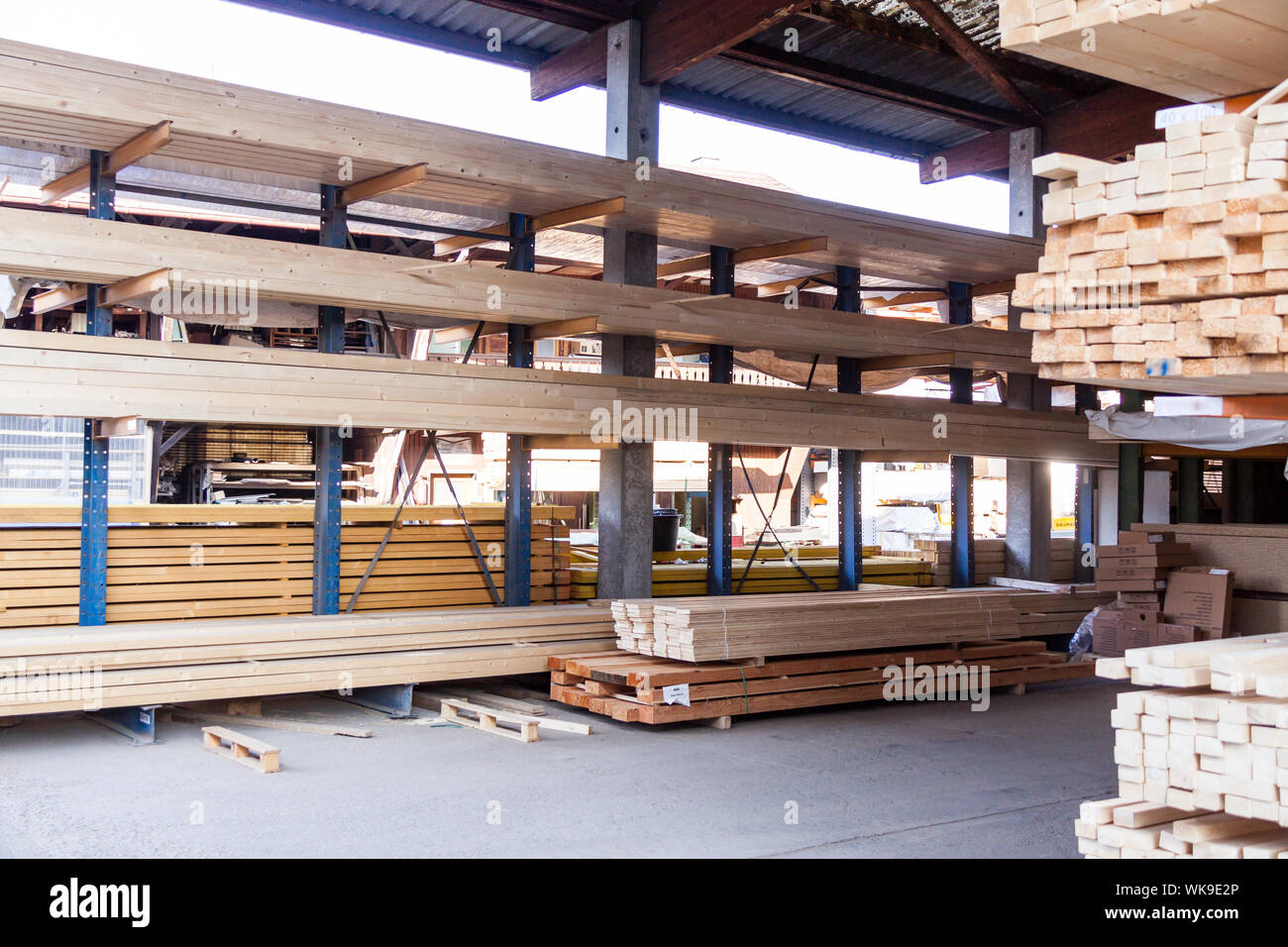 Wooden panels stored inside an industrial warehouse on metal shelving ...