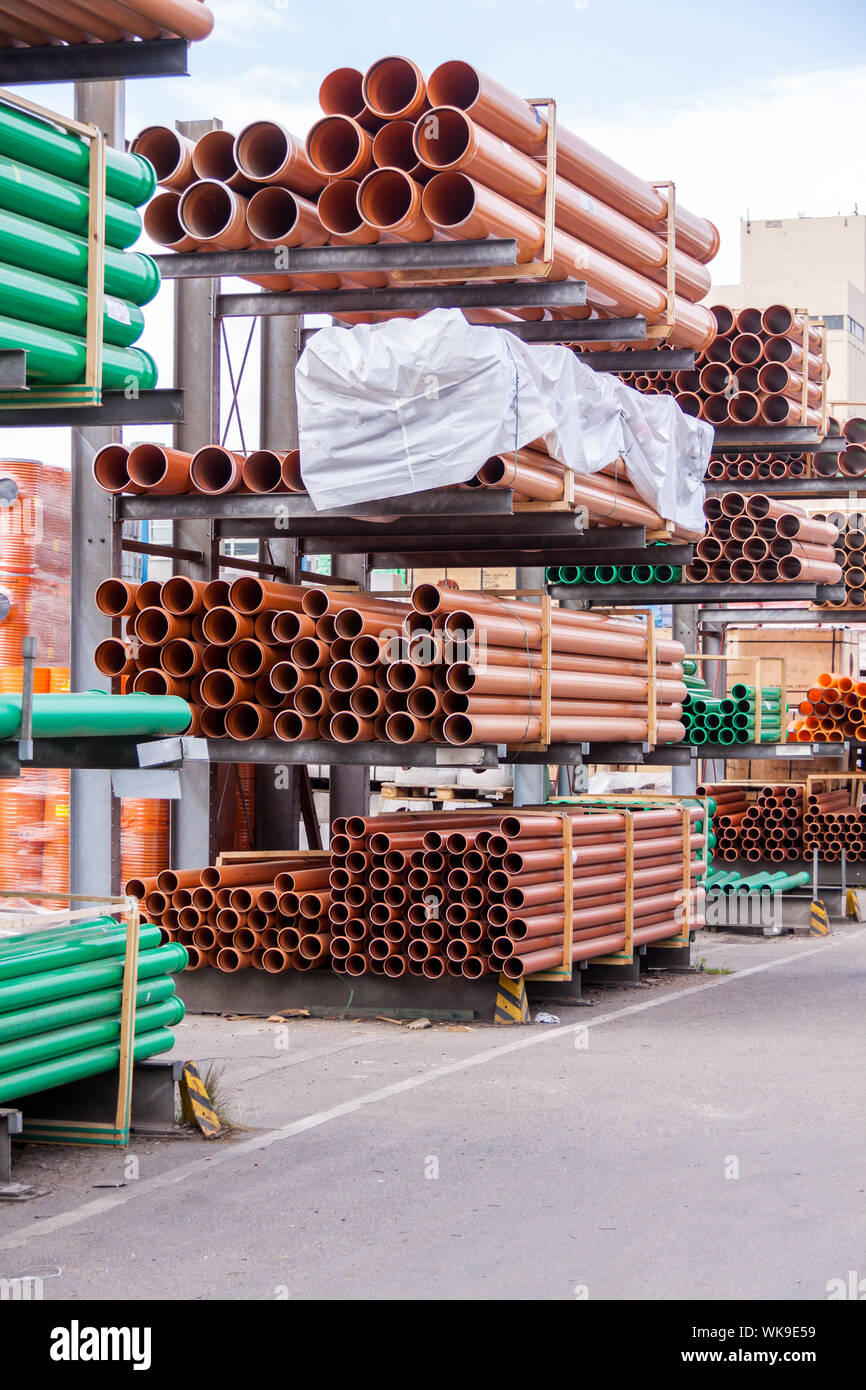 Plastic pipes stacked in a factory or warehouse yard for use in ...