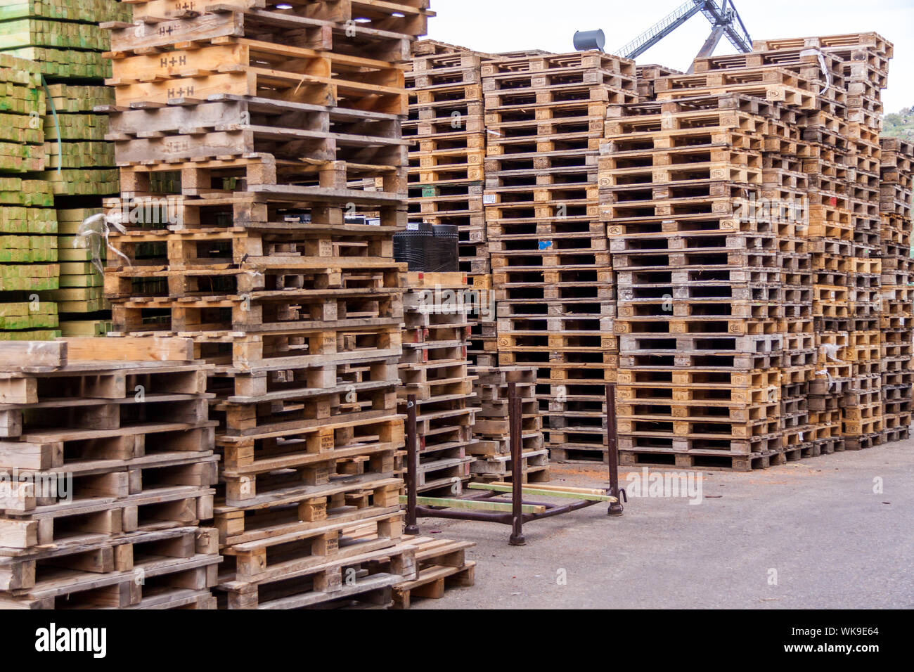 Stacks of old wooden pallets in a commercial or industrial yard used ...