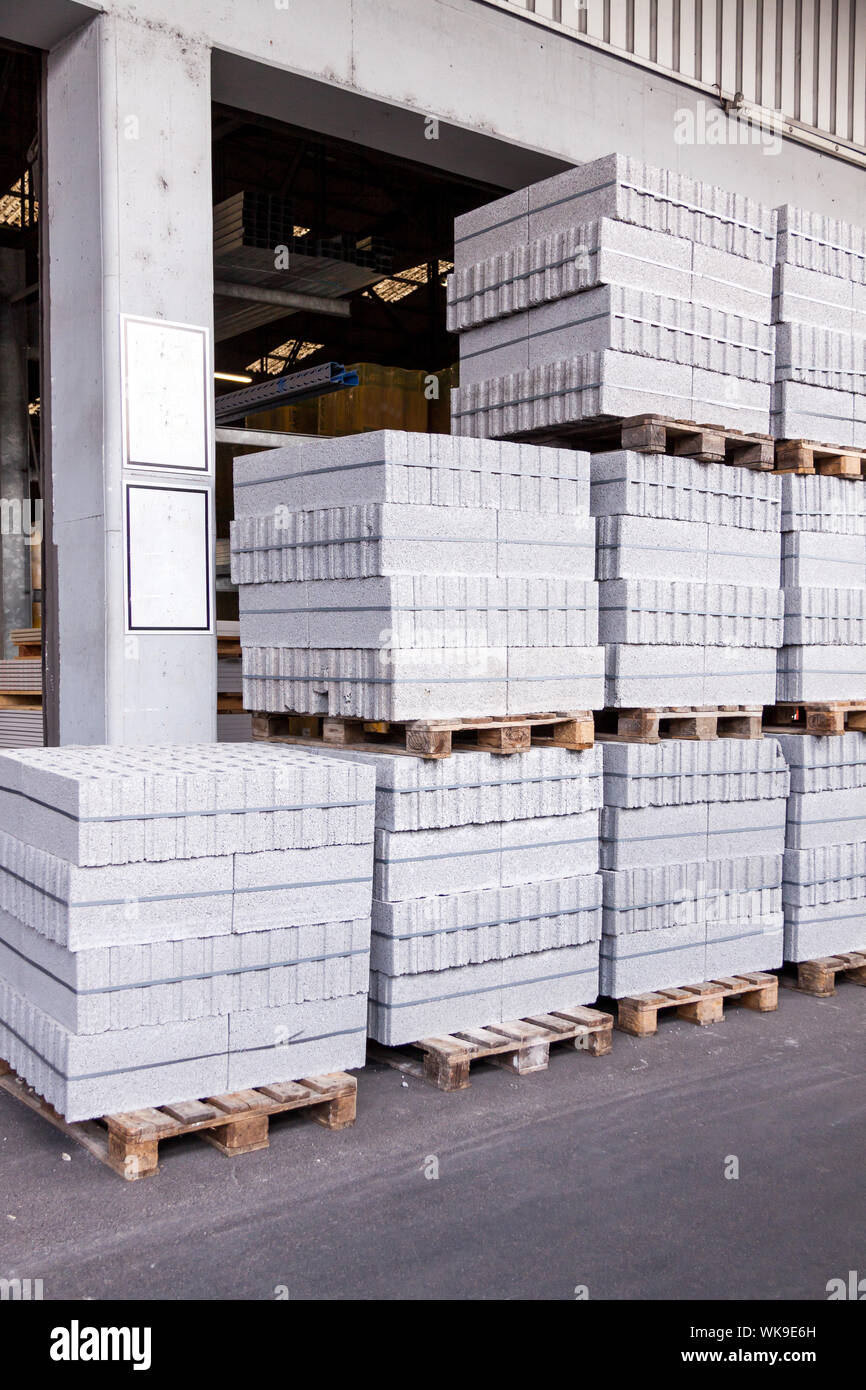 Cement building blocks stacked on pallets used for transportation and ...
