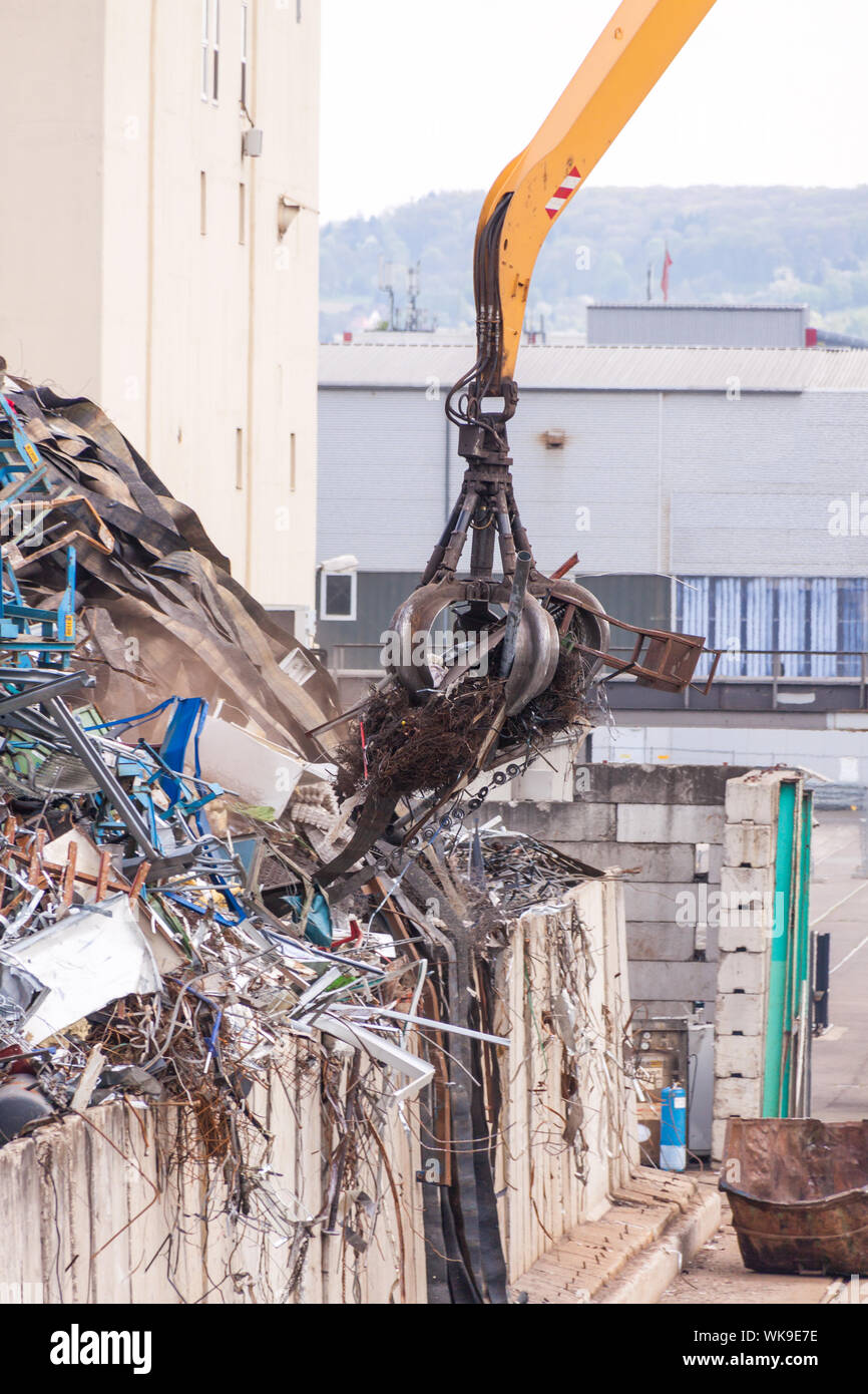 Open barge being loaded or offloaded at a wharf on an urban waterway or ...