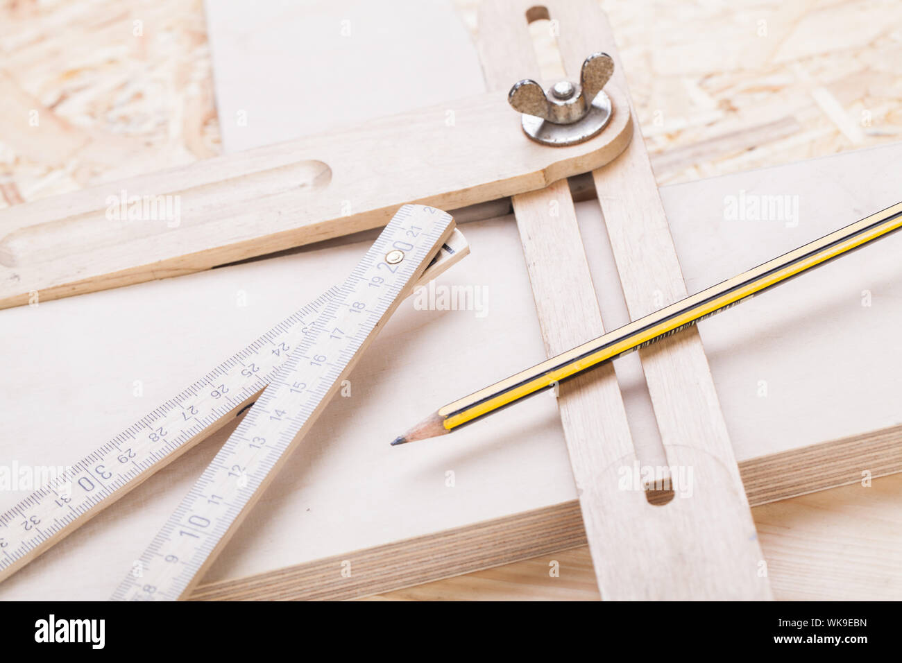 Close up view of a colorful yellow carpenters level, ruler and right ...