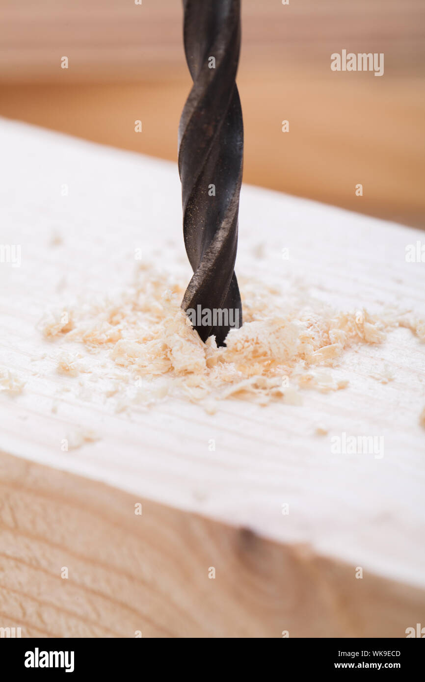 Battery operated hand drill standing amongst planks of new wood with a ...