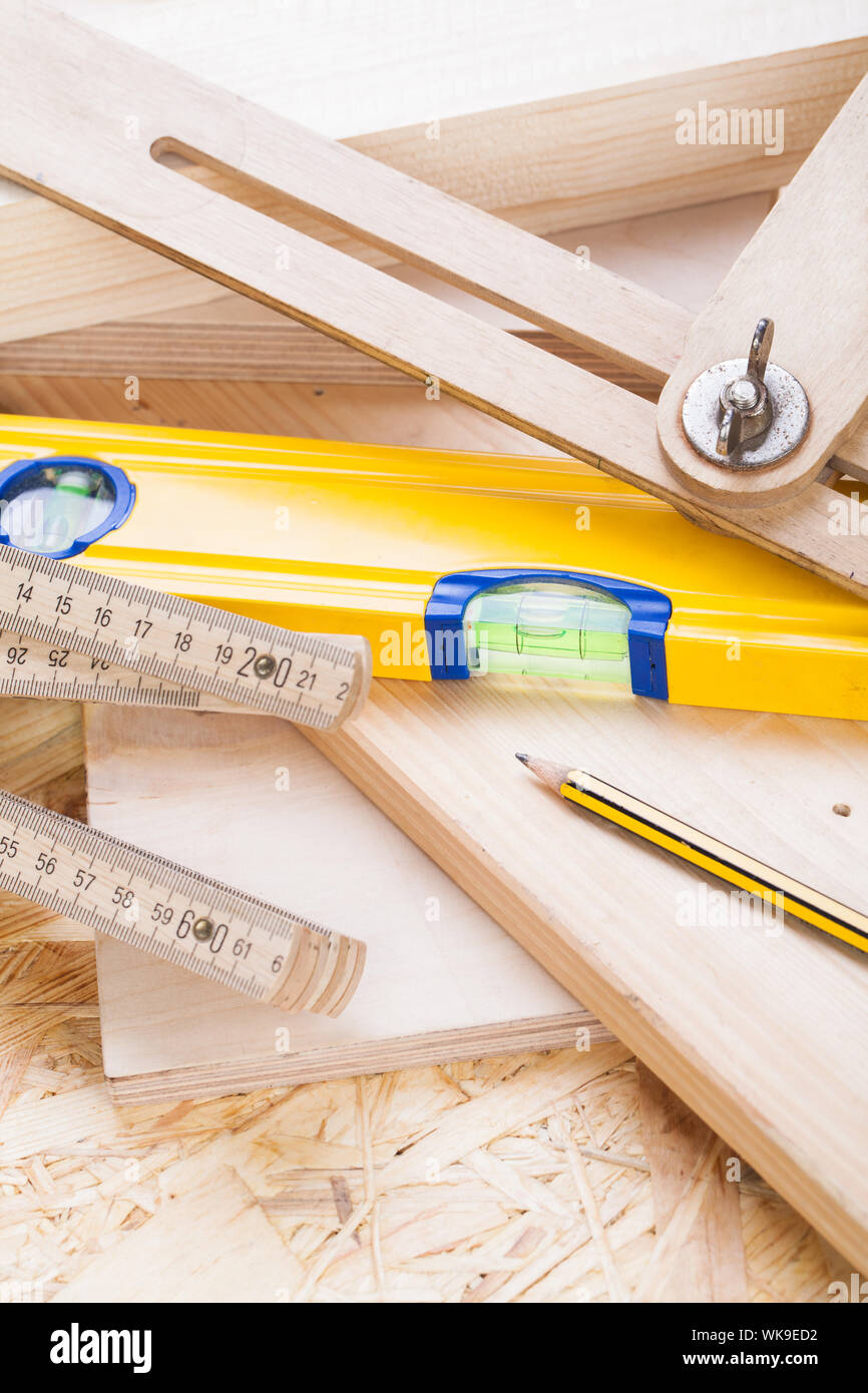 Close up view of a colorful yellow carpenters level, ruler and right ...