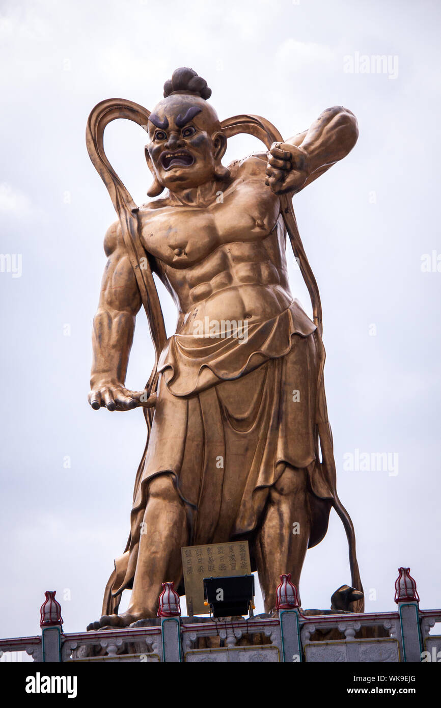 Interior of an ornate Asian temple with statues f deities in recesses ...