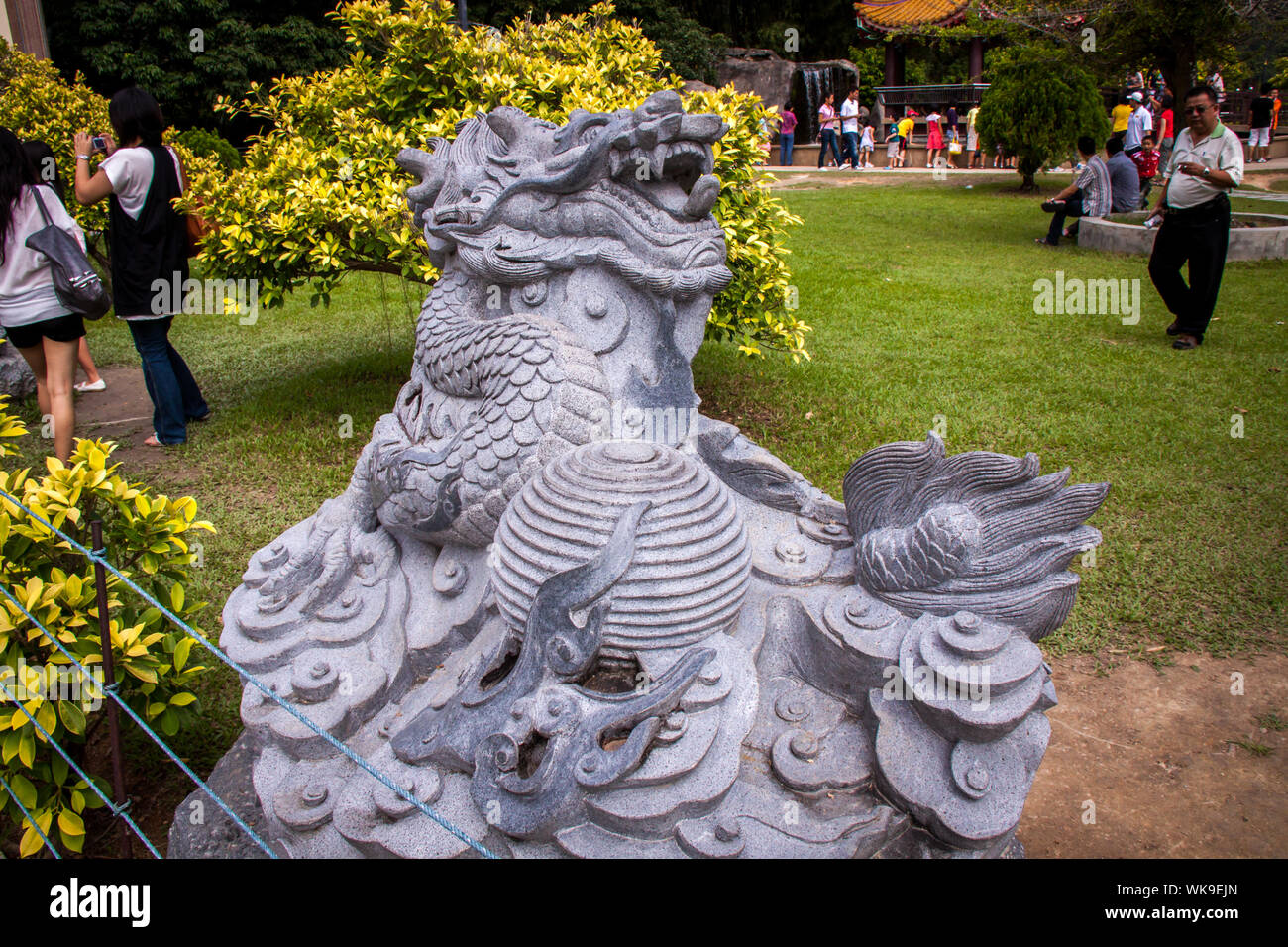 Interior of an ornate Asian temple with statues f deities in recesses ...