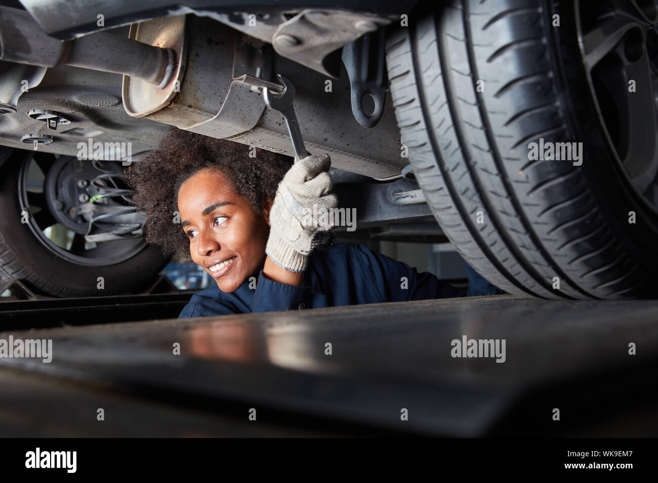 African woman as a mechatronics apprentice at the inspection of car ...