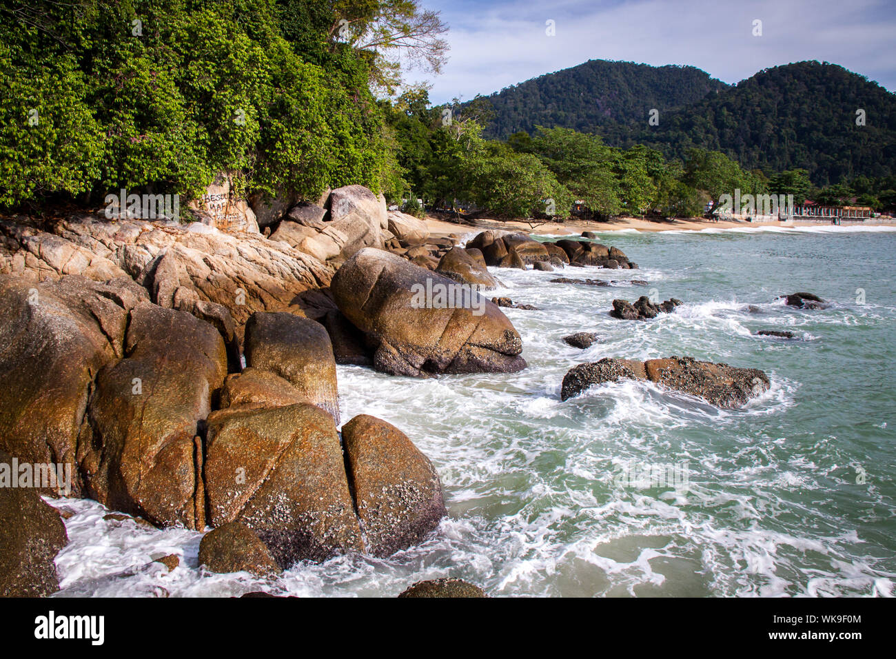 Beautiful tropical beach with lush vegetation fringing golden sand and ...