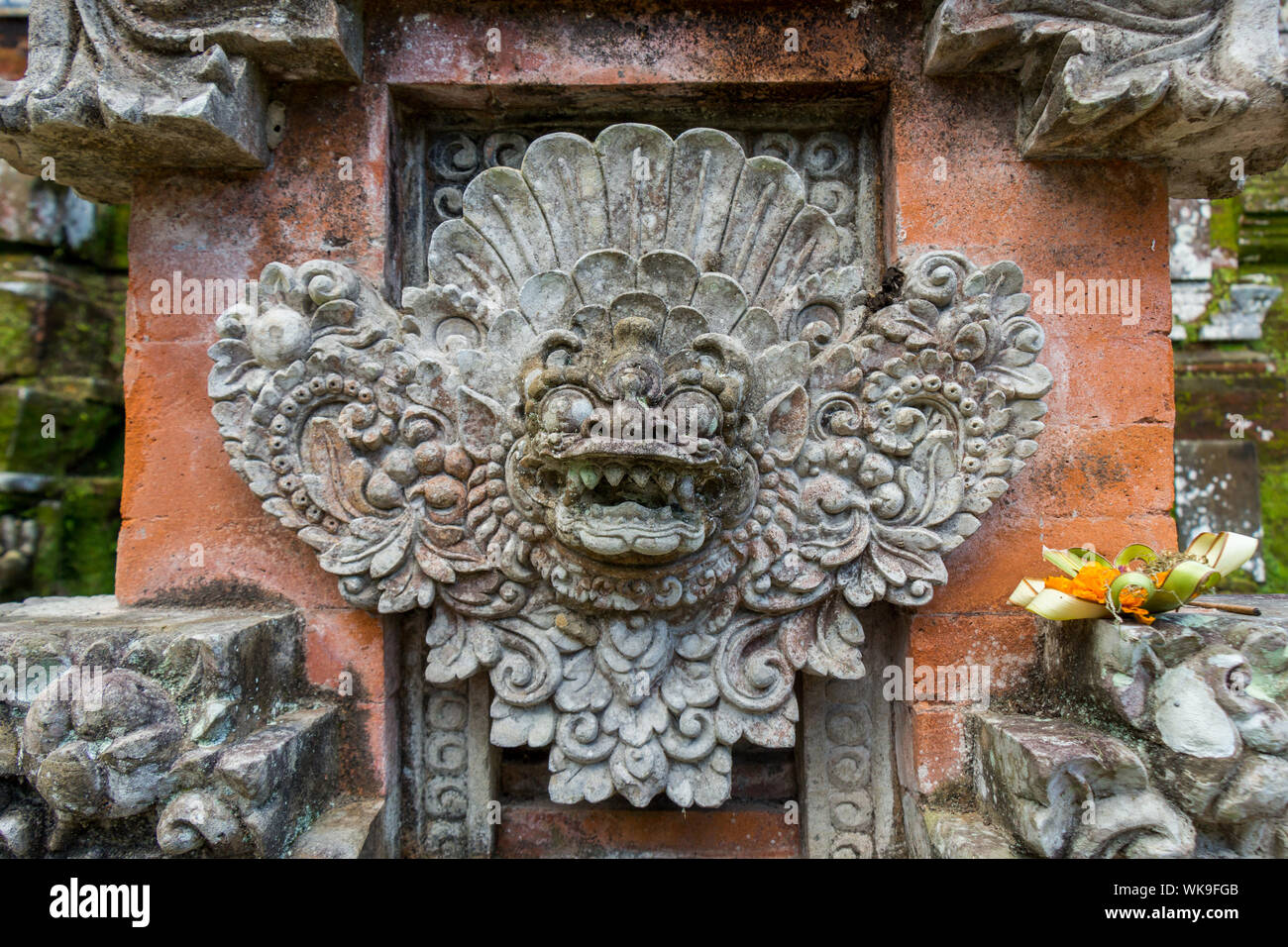 Ornate intricately carved and decorated stone column in formal Balinese ...