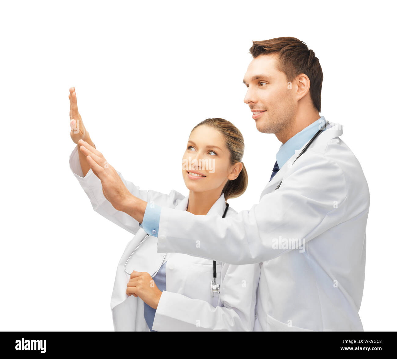 two young doctors working with something imaginary Stock Photo - Alamy