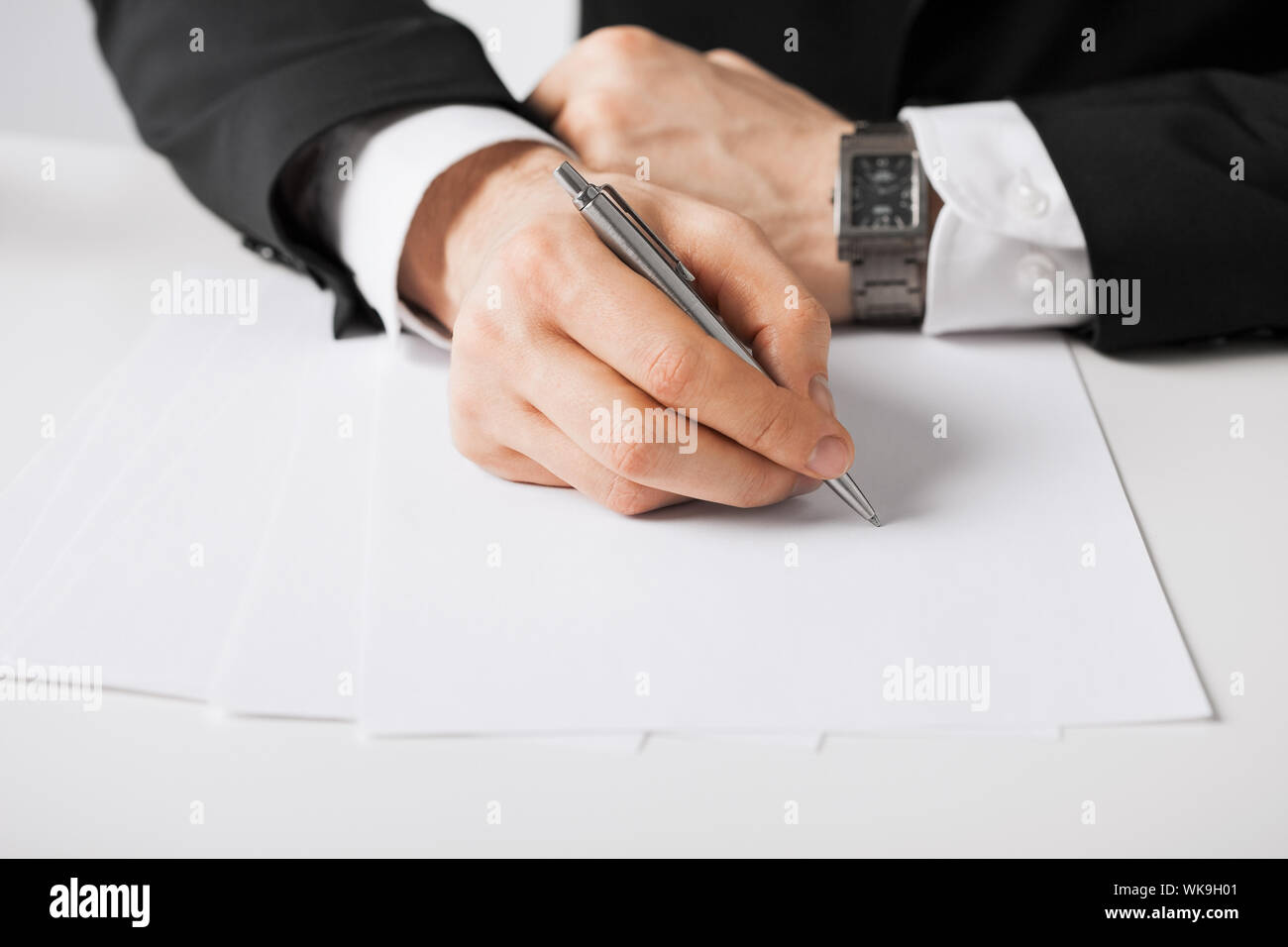picture of businessman writing something on the paper Stock Photo - Alamy