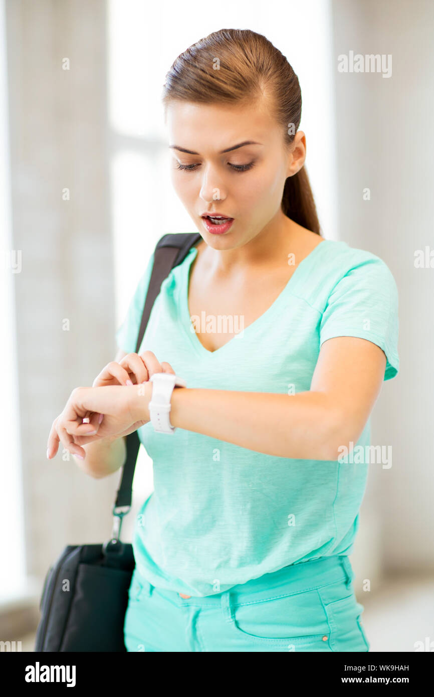 surprised student girl looking at clock Stock Photo - Alamy