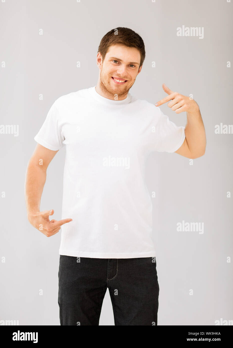 picture of smiling man pointing at blank white t-shirt Stock Photo - Alamy