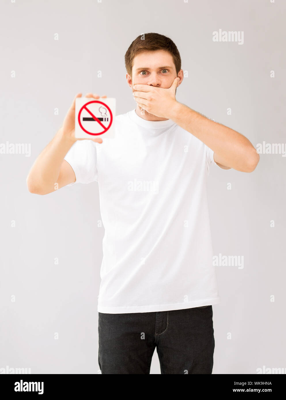 young man holding no smoking sign Stock Photo - Alamy