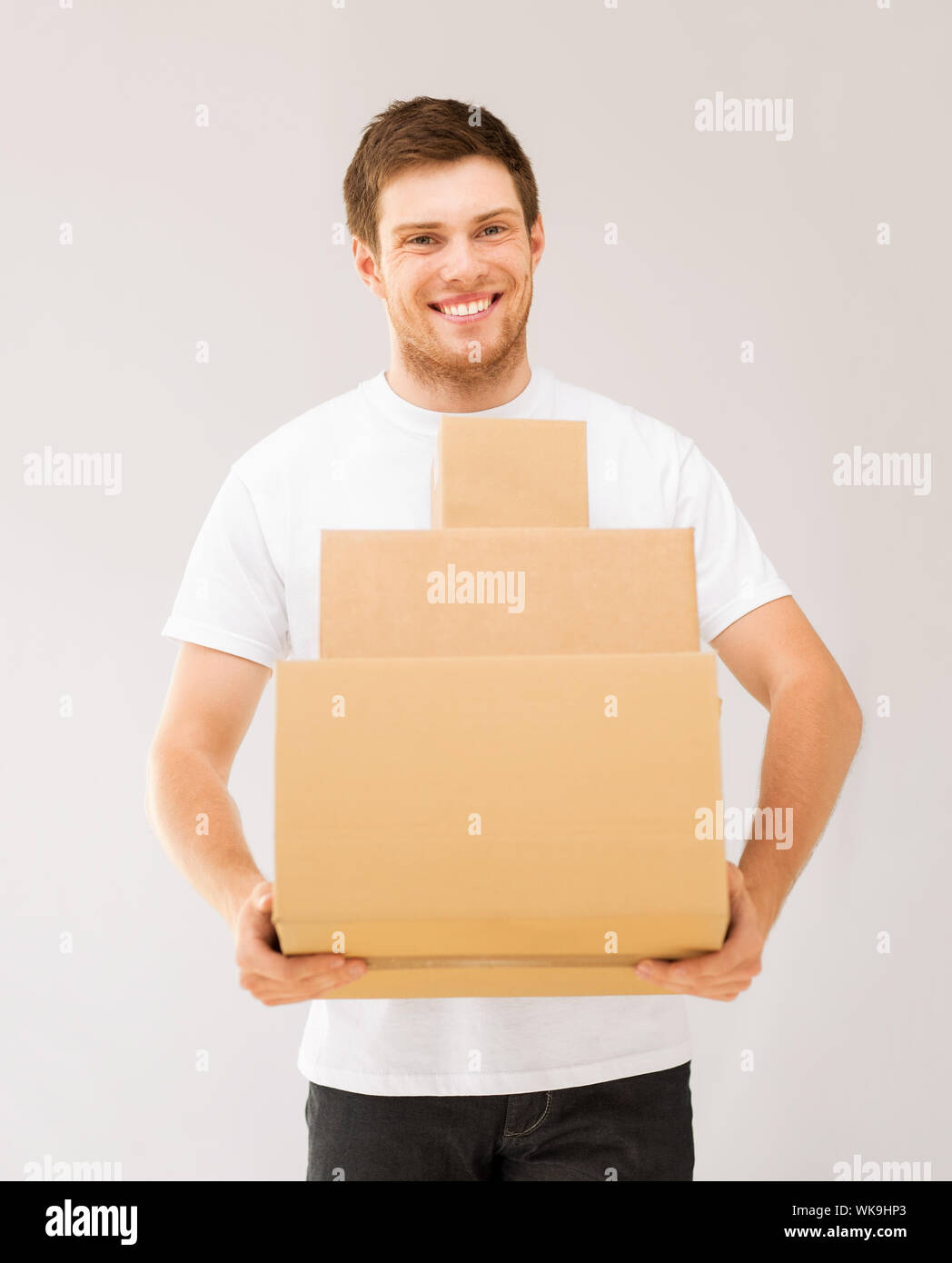 smiling man carrying carton boxes Stock Photo - Alamy
