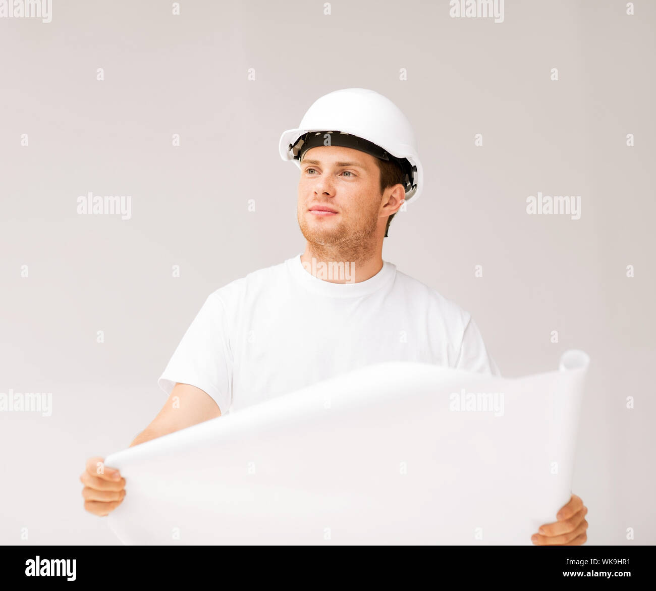 male architect looking at blueprint Stock Photo - Alamy