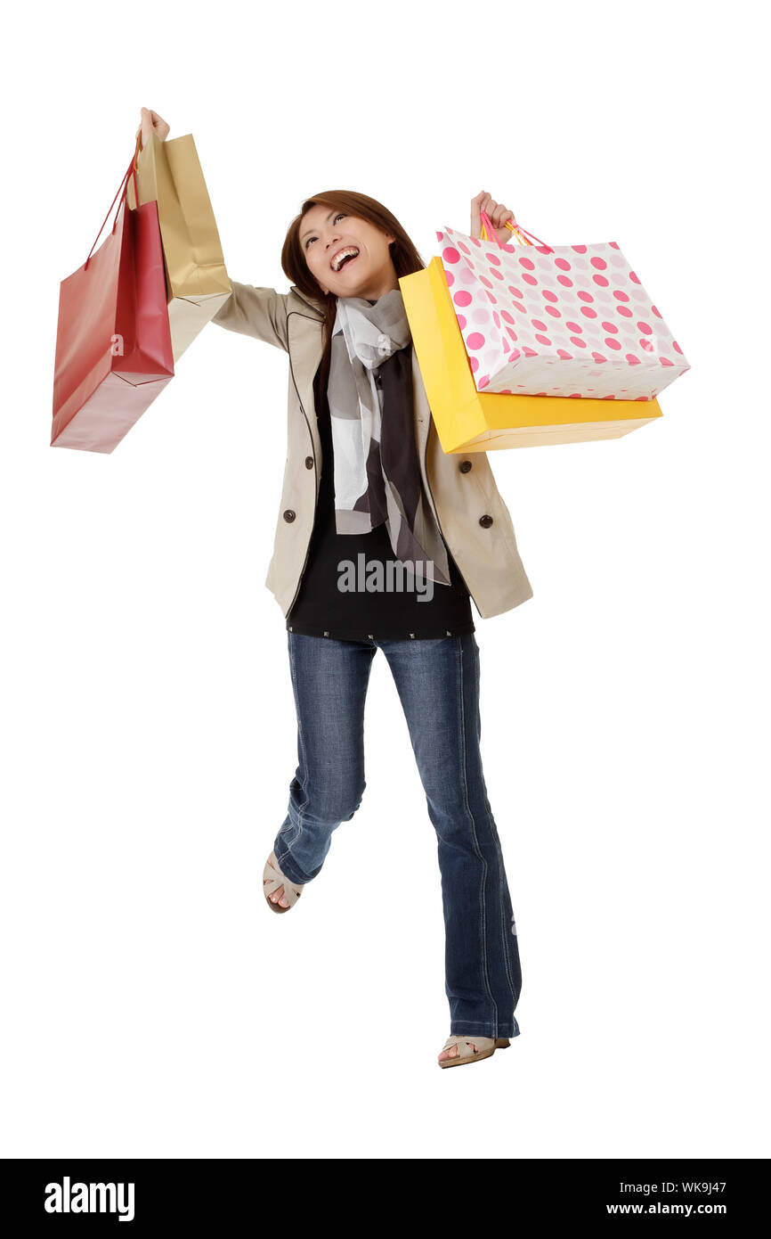 Happy shopping woman with exciting expression holding bags isolated ...