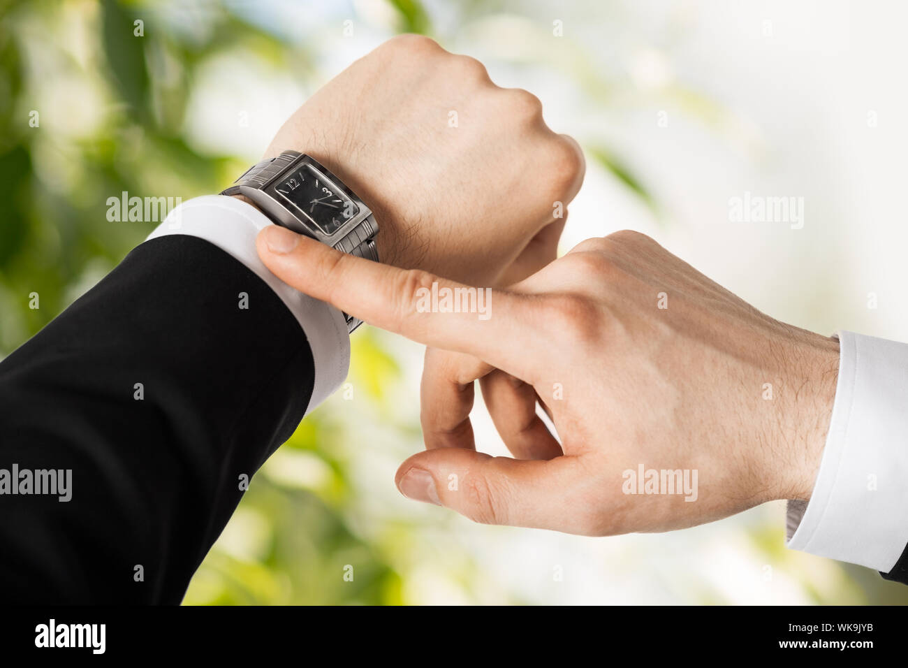 man looking at wristwatch Stock Photo - Alamy