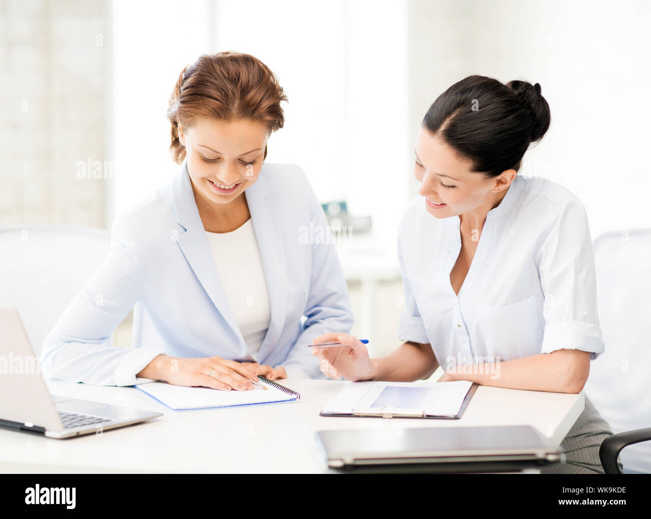 Two smiling businesswomen working hi-res stock photography and images ...
