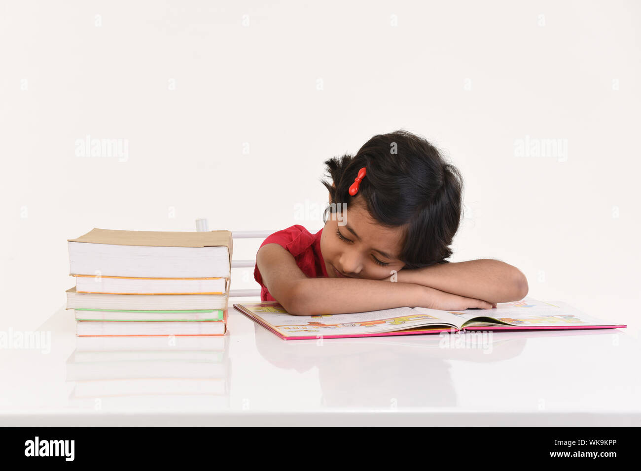 Girl napping on a desk Stock Photo - Alamy