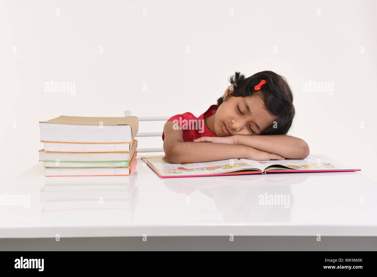 Girl napping on a desk Stock Photo - Alamy