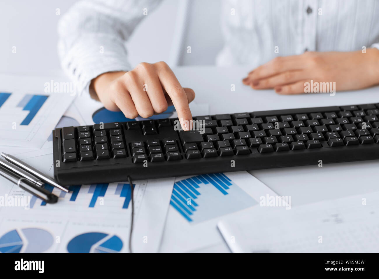 picture of woman hand pressing enter button on keyboard Stock Photo - Alamy