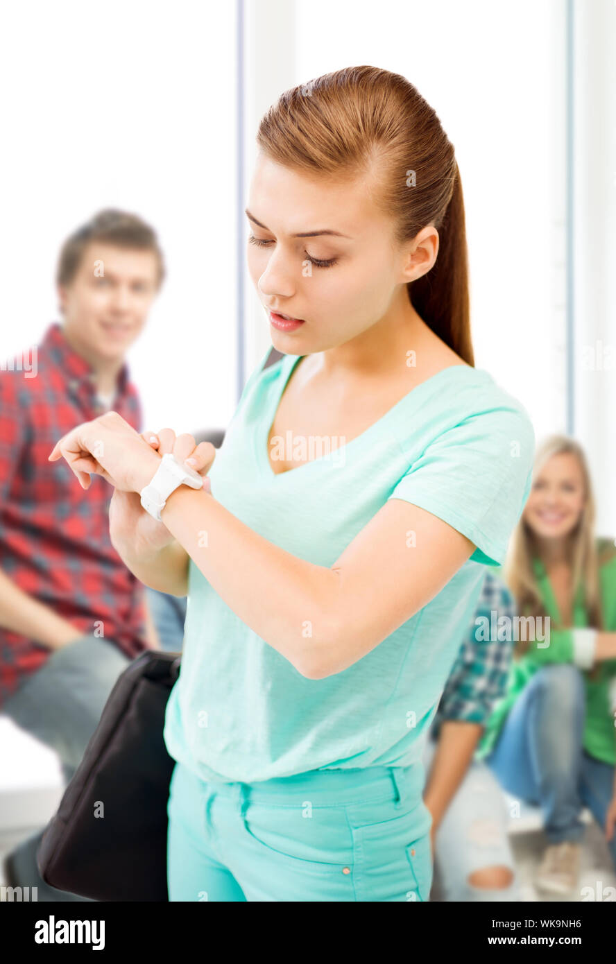student girl looking at wristwatch Stock Photo - Alamy