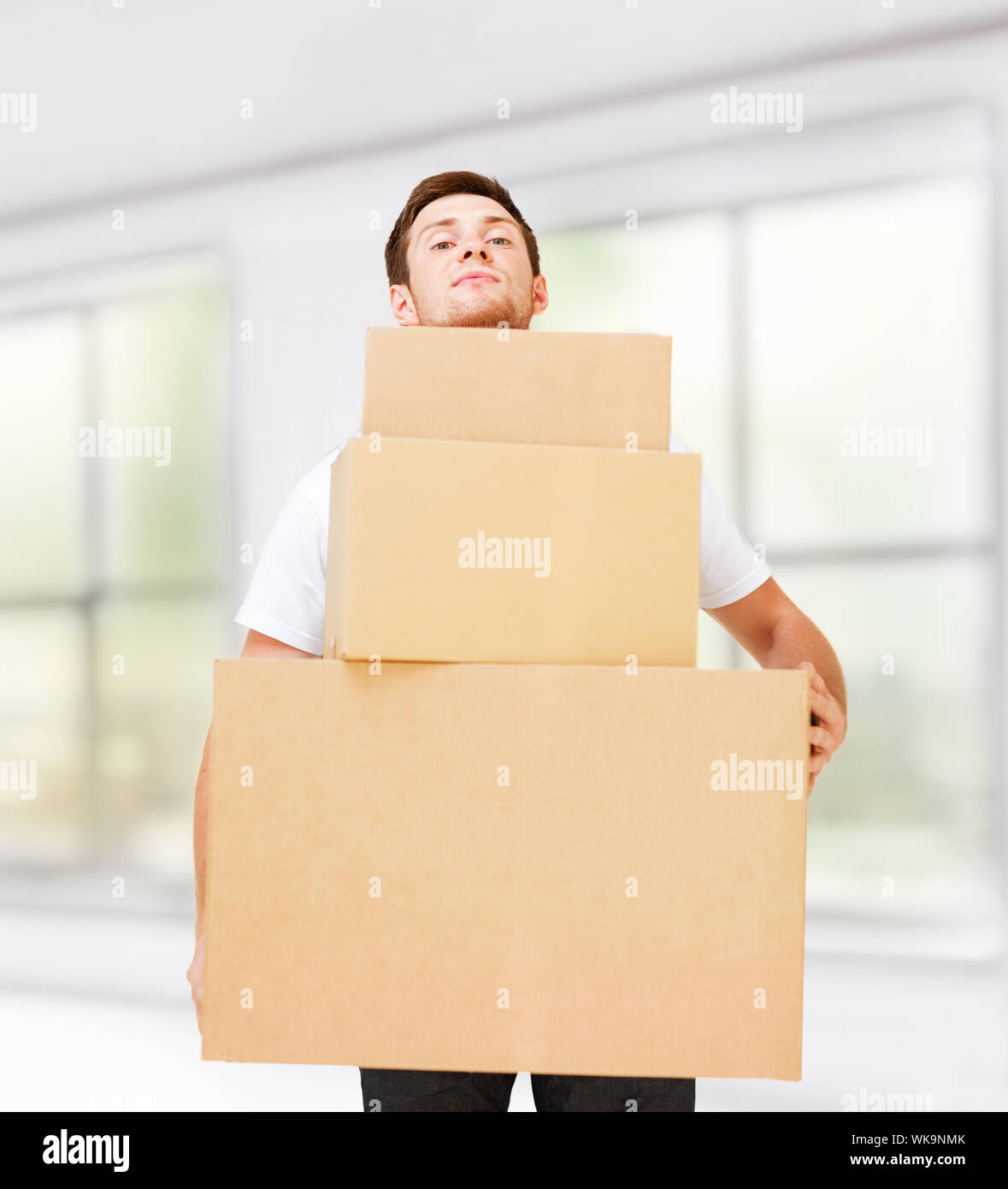 young man carrying carton boxes Stock Photo - Alamy