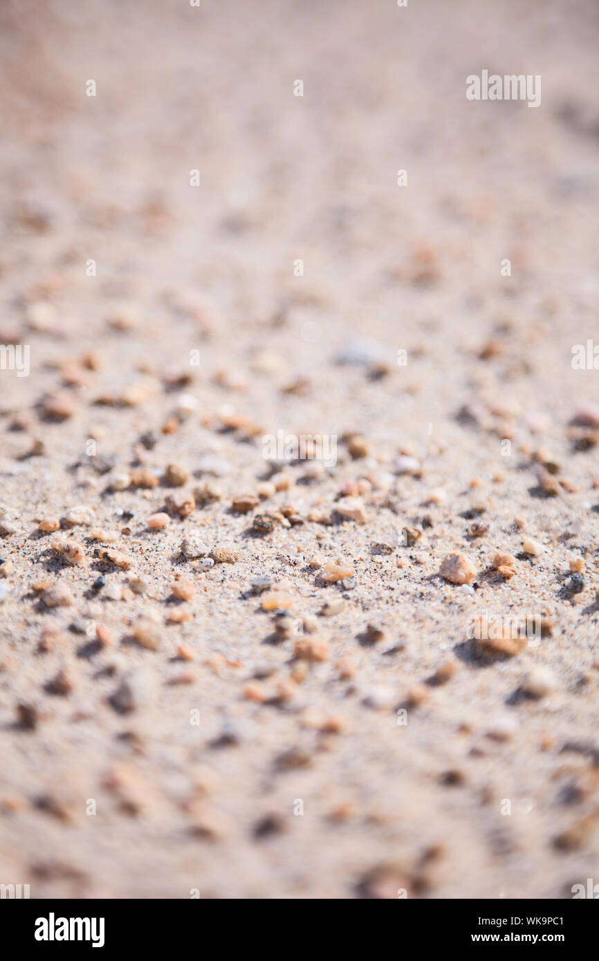 Surface of a sandy ground covered with small stones Stock Photo - Alamy