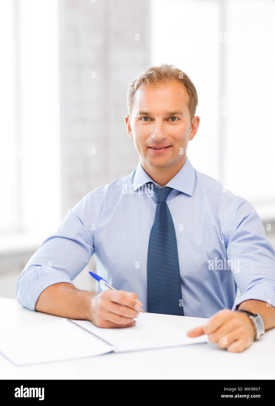 Handsome man writing on notebook hi-res stock photography and images ...