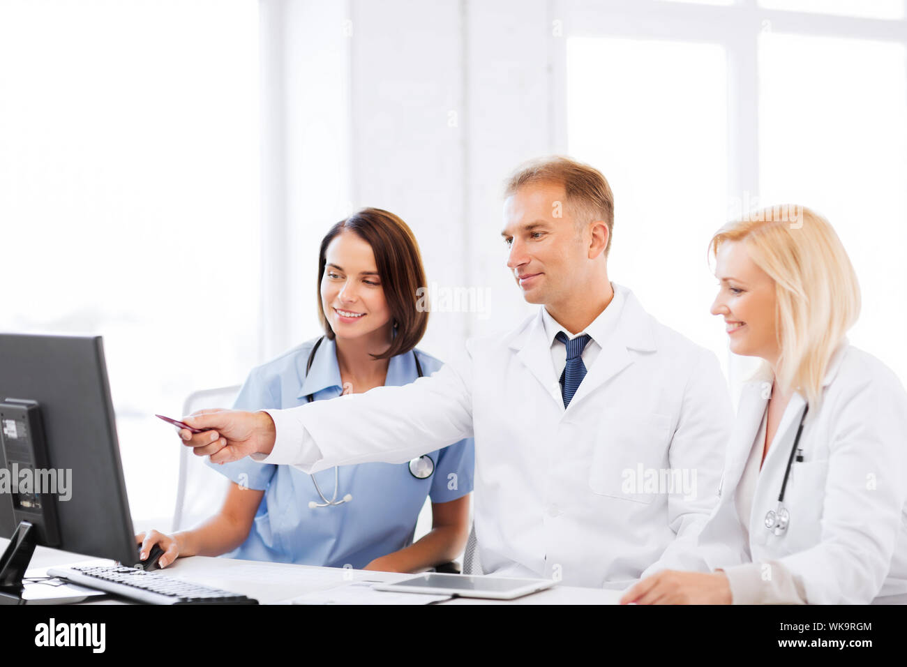 doctors looking at computer on meeting Stock Photo - Alamy