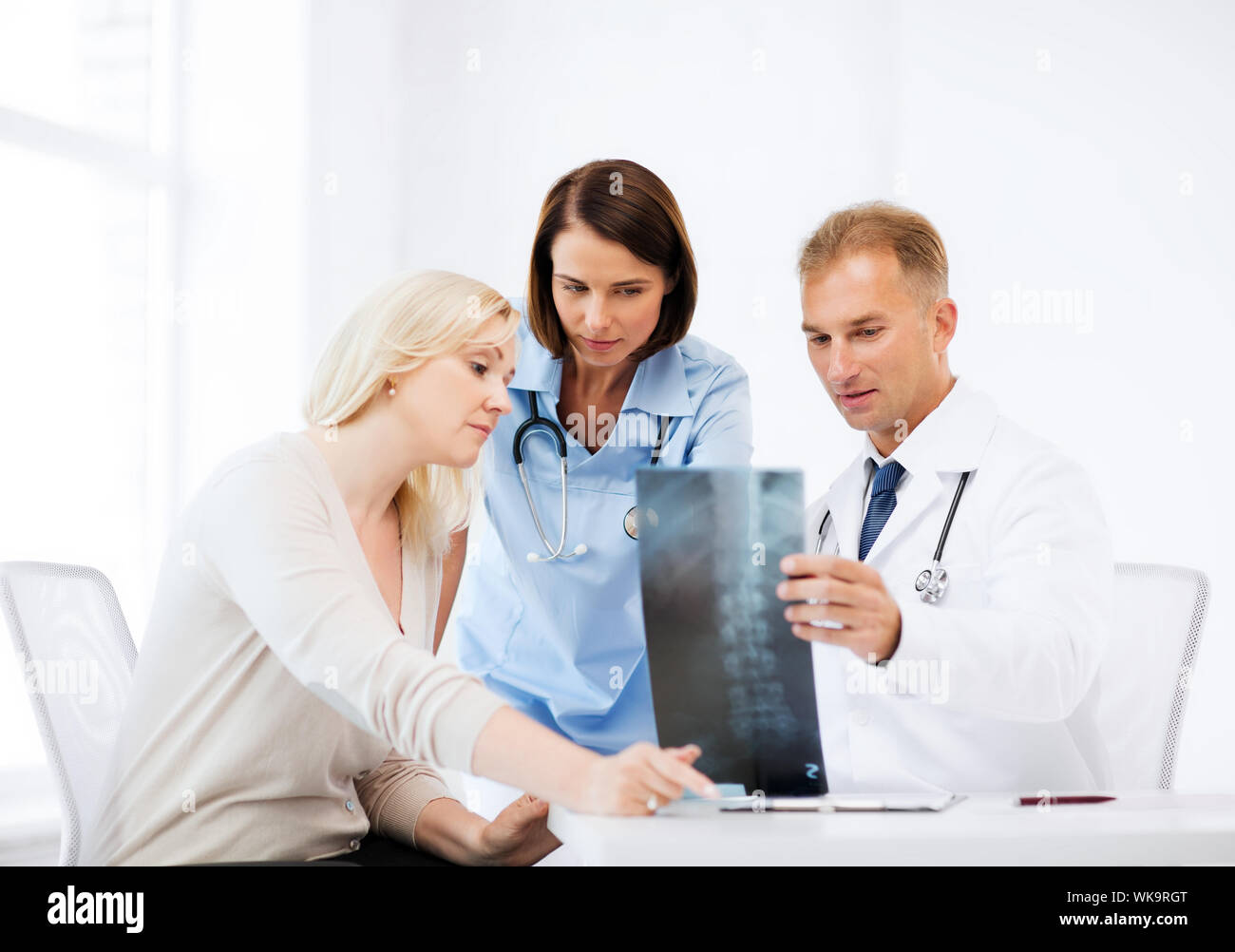 doctors with patient looking at x-ray Stock Photo - Alamy