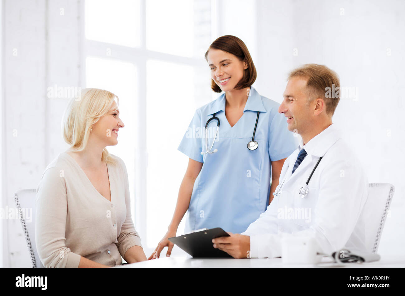 healthcare and medical concept - doctor and nurse with patient in ...